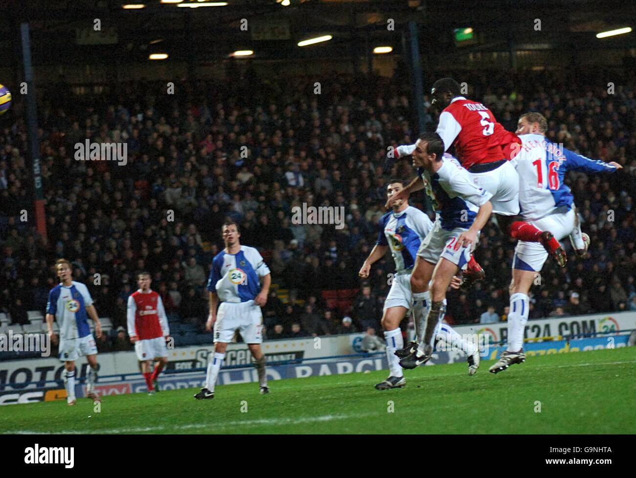 Arsenal's Kolo Toure (2nd from right) rises highest to win the ball and ...
