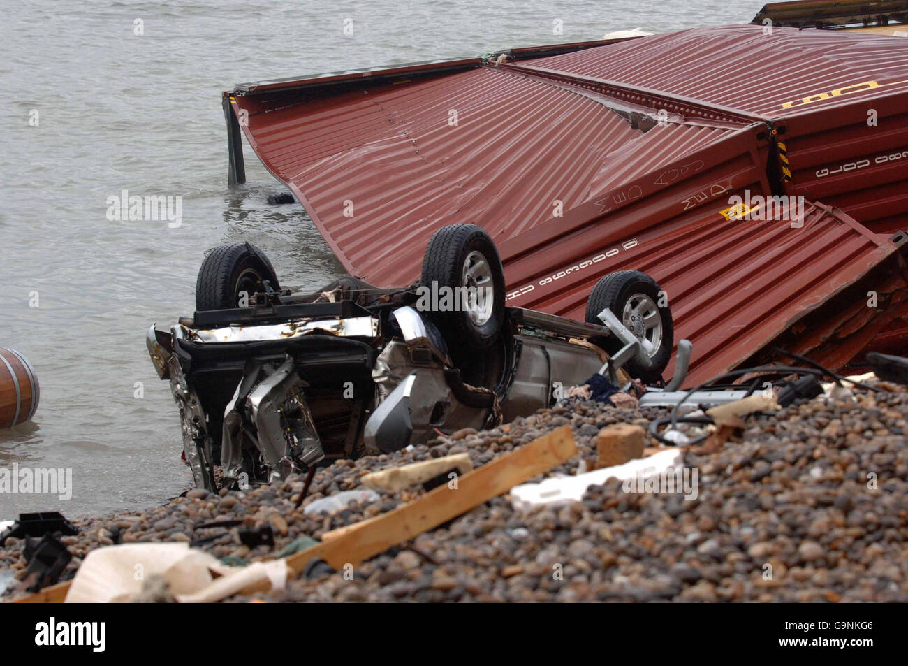 A mangled container and vehicle lie abandoned on the pebbles of ...