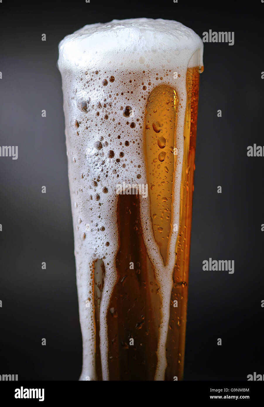 Glass of cold beer on black background Stock Photo - Alamy