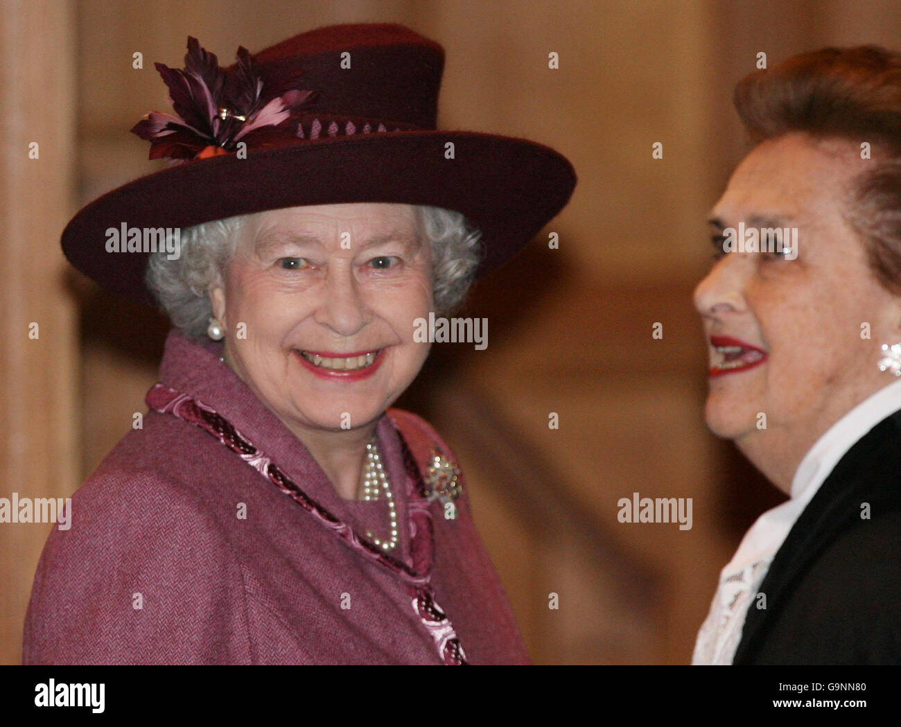 Britain's Queen Elizabeth II is shown around the International Court of ...