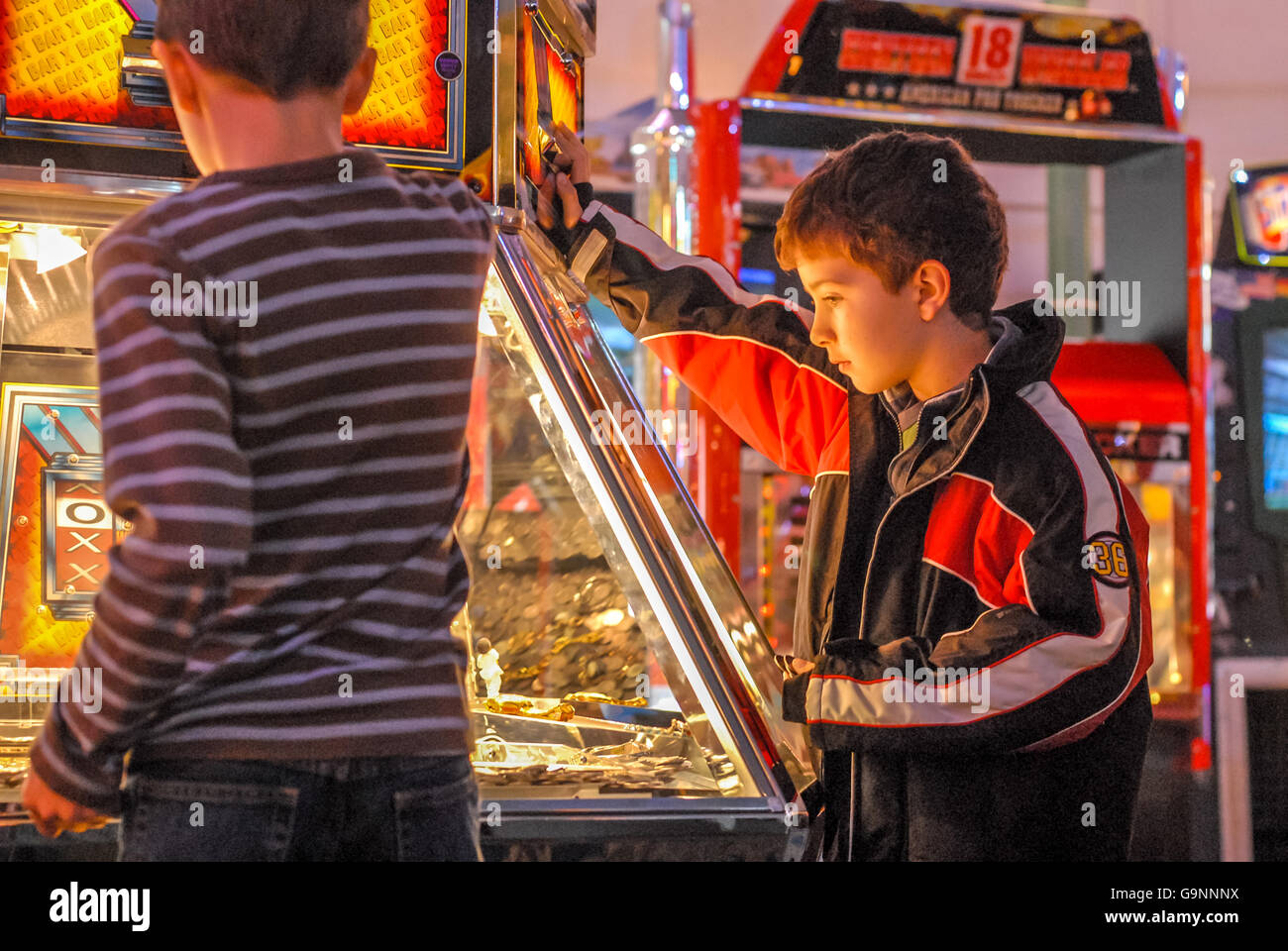 Children playing in a seaside amusement arcade Stock Photo - Alamy