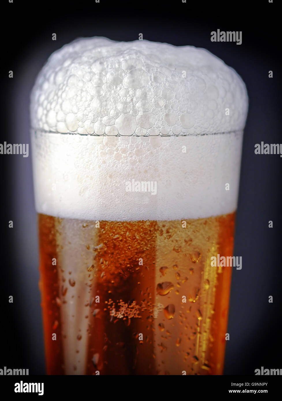 Glass of cold beer on black background Stock Photo - Alamy