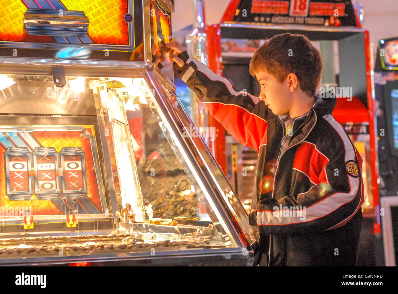 Children playing in a seaside amusement arcade Stock Photo - Alamy