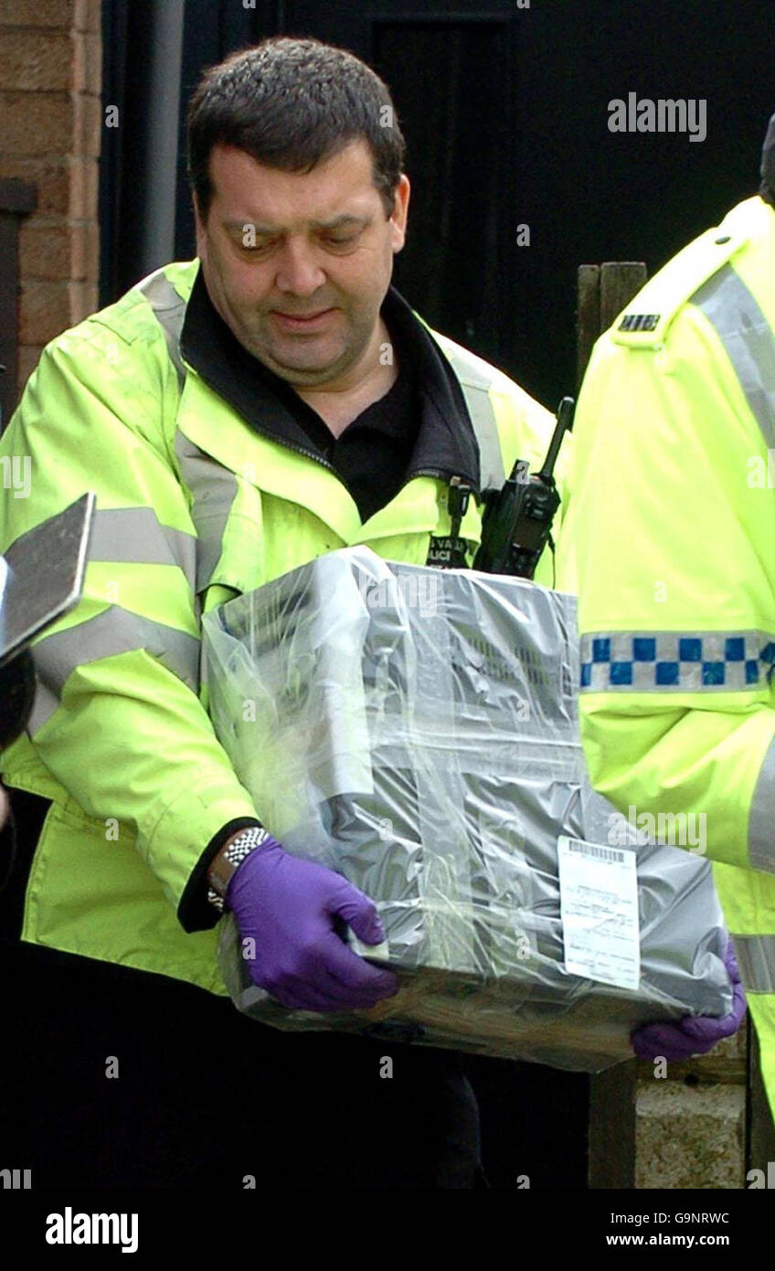 Police remove objects from a house in Welstead Road, Cambridge, after a ...