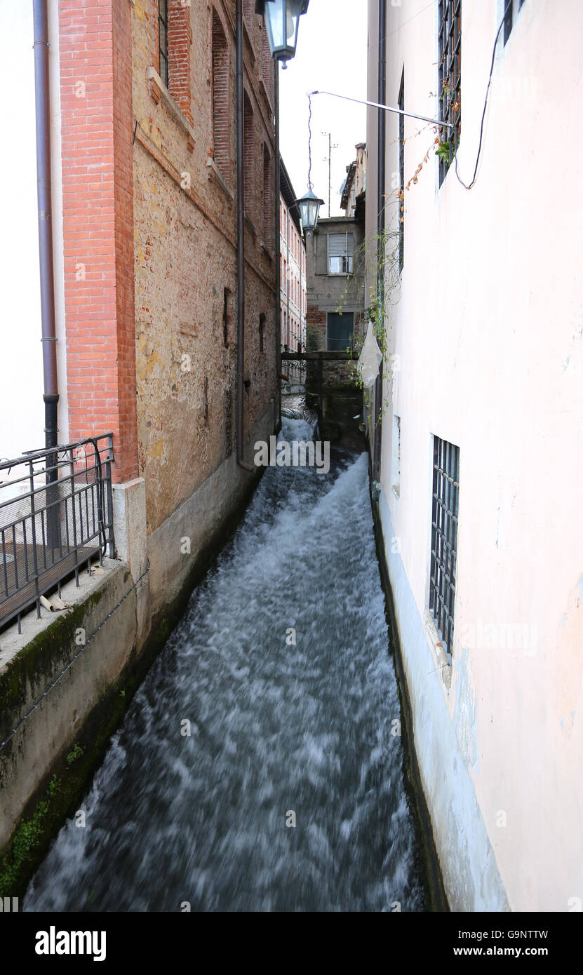stream with water flowing in the middle of the industrial abandoned ...