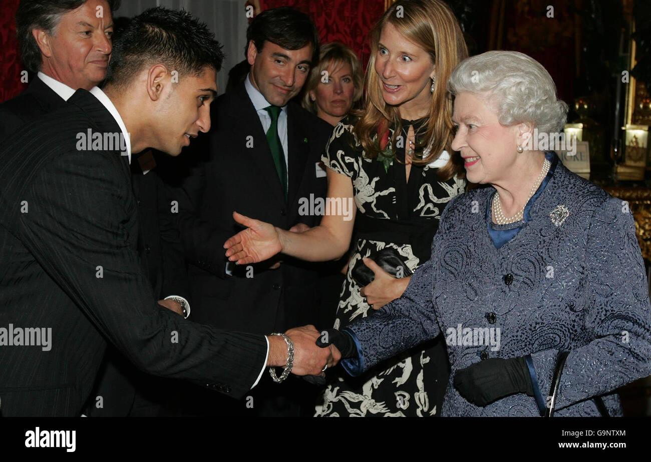 Britains Queen Elizabeth II (right) shakes hands with boxer Amir Khan ...