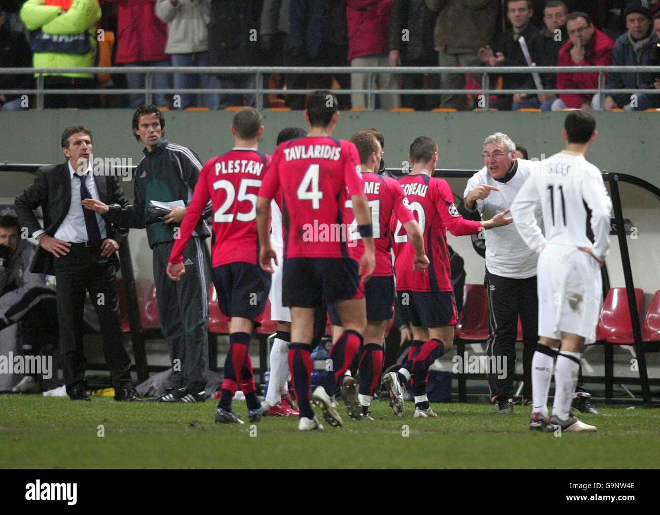 Lille manager Claude Puel (left) watches on as the coach tells his ...