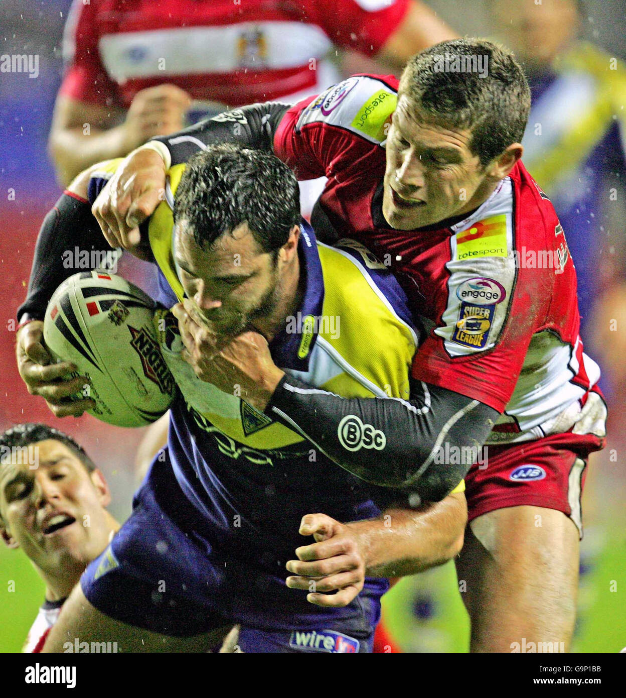 Wigan's Bryan Fletcher (right) prevents Warrington's Adrian Morley from ...