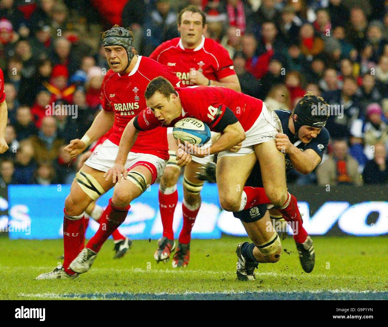 Wales' Mark Jones is tackled by Scotland's Simon Taylor (right) during ...