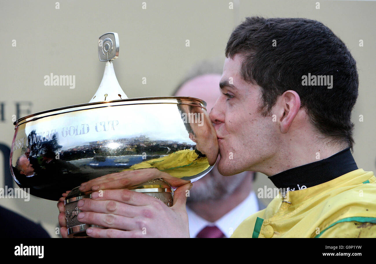 Jockey Andrew McNamara kisses the Hennessy Cognac Gold Cup after taking ...