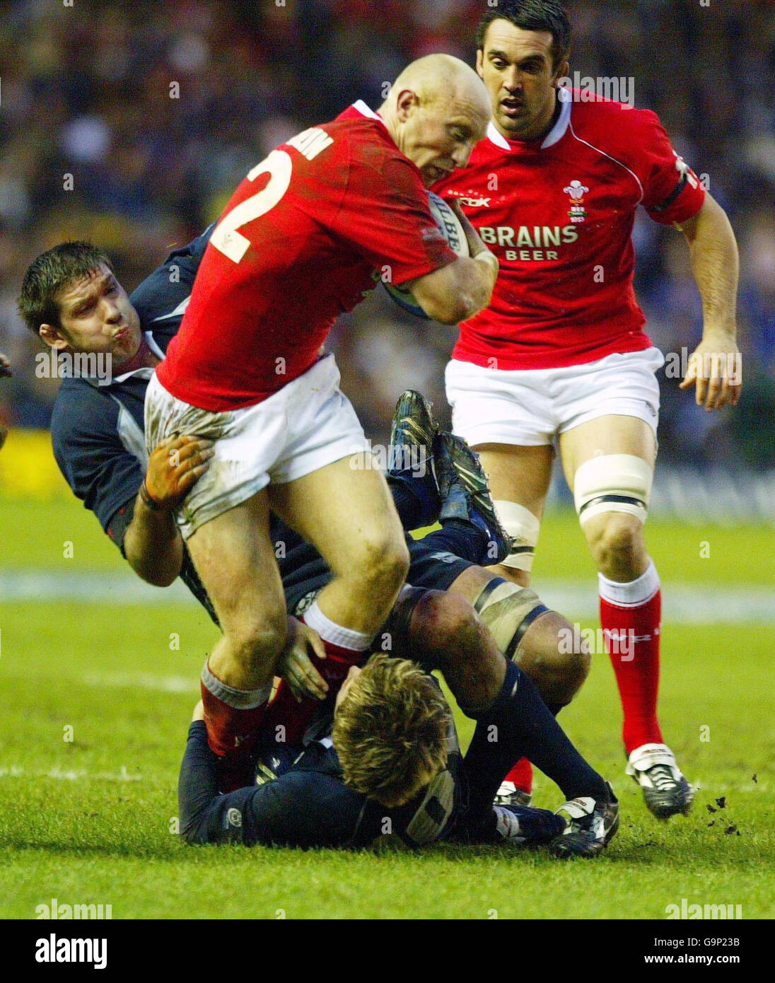 Wales' Thomas Shanklin is brought down by Scotland's Phil Godman and ...
