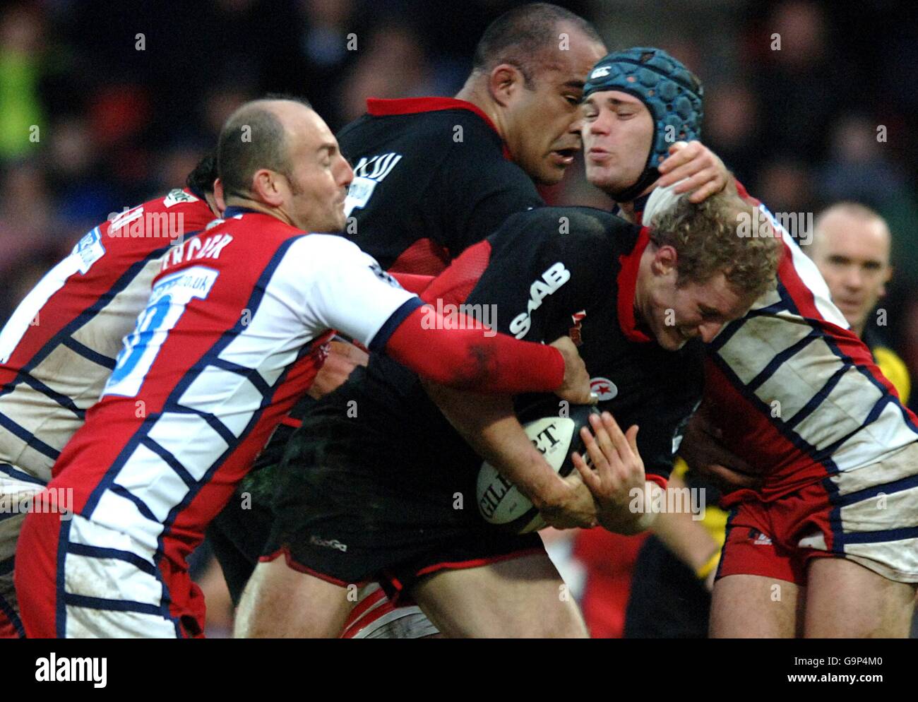 Saracens' Dan Scarbrough tries to break through the Gloucester defence ...