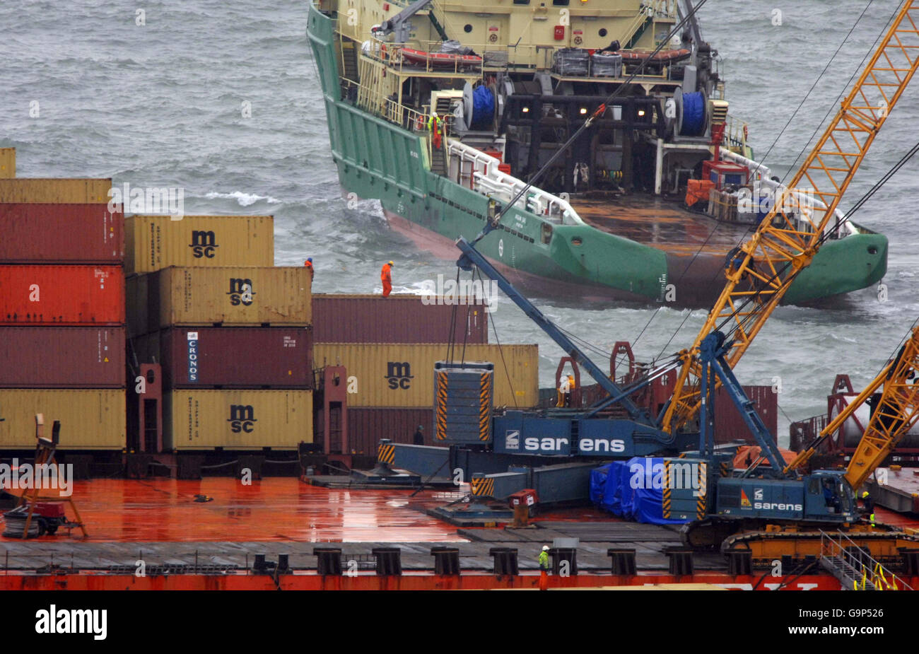 Containers continue to be lifted from the beached MSC Napoli close to ...