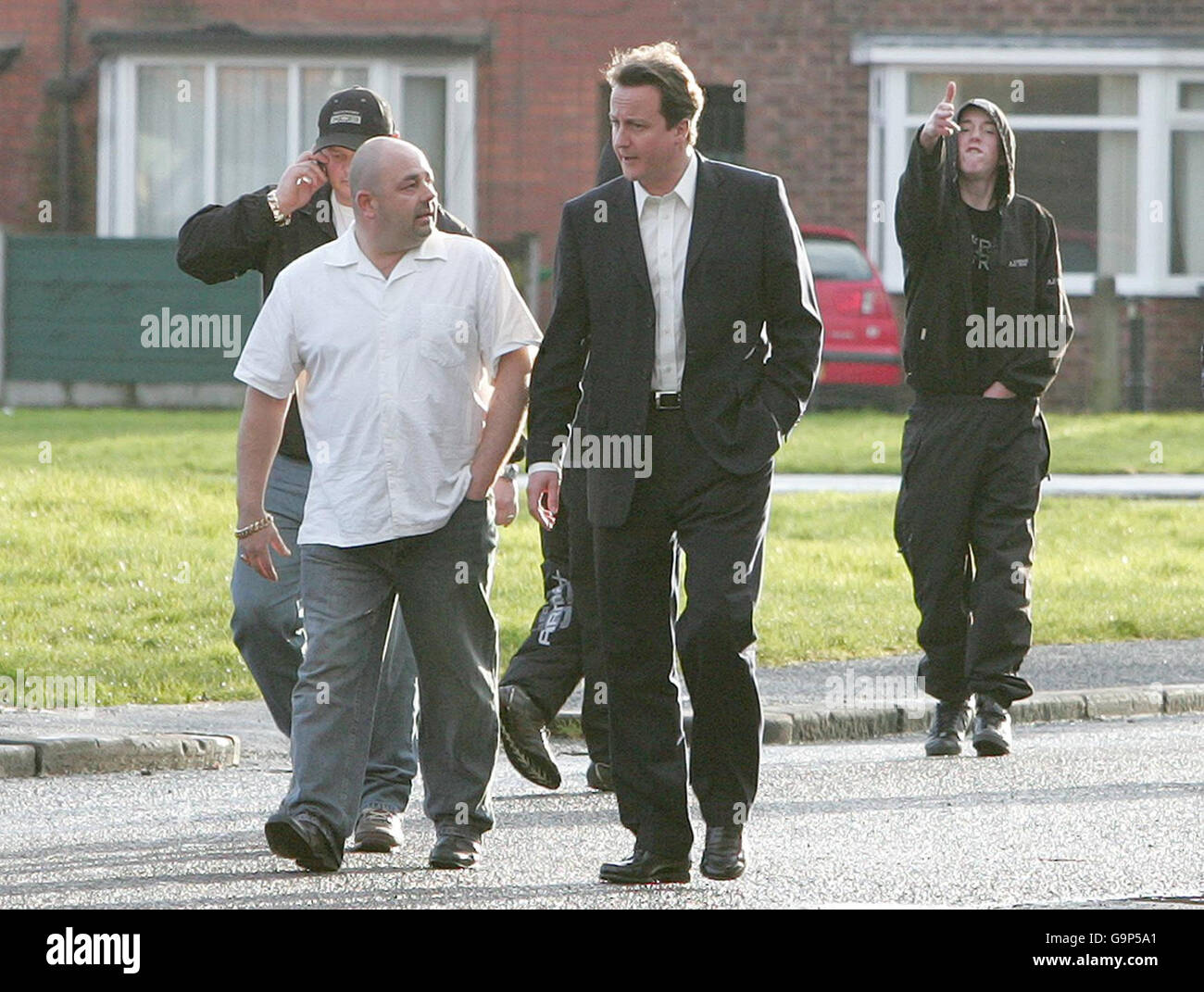 Leader of the Conservative Party David Cameron (centre) walks through ...