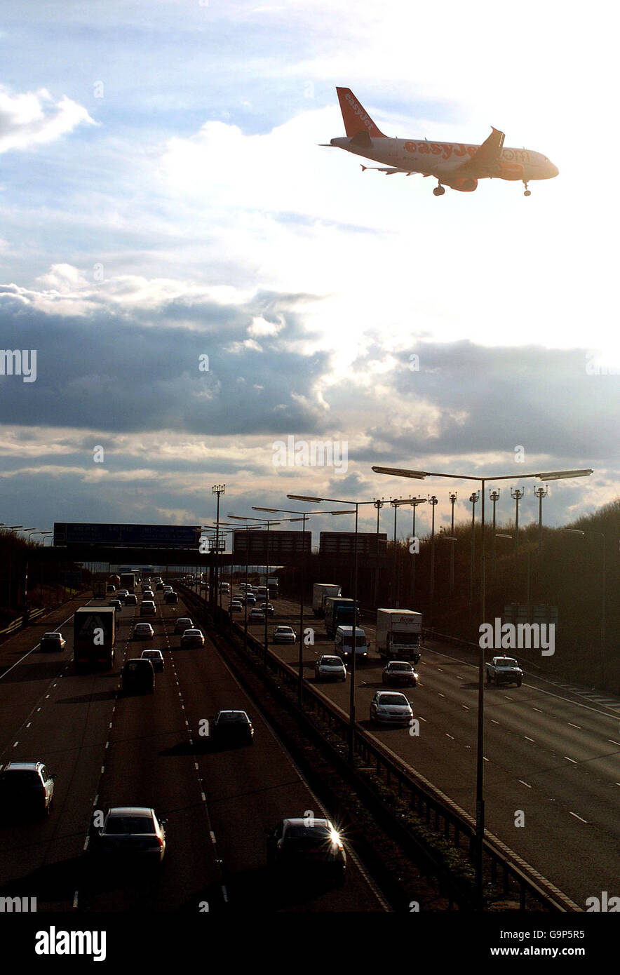 An Easy Jet passenger plane flies over the M1 Motorway on the way to ...