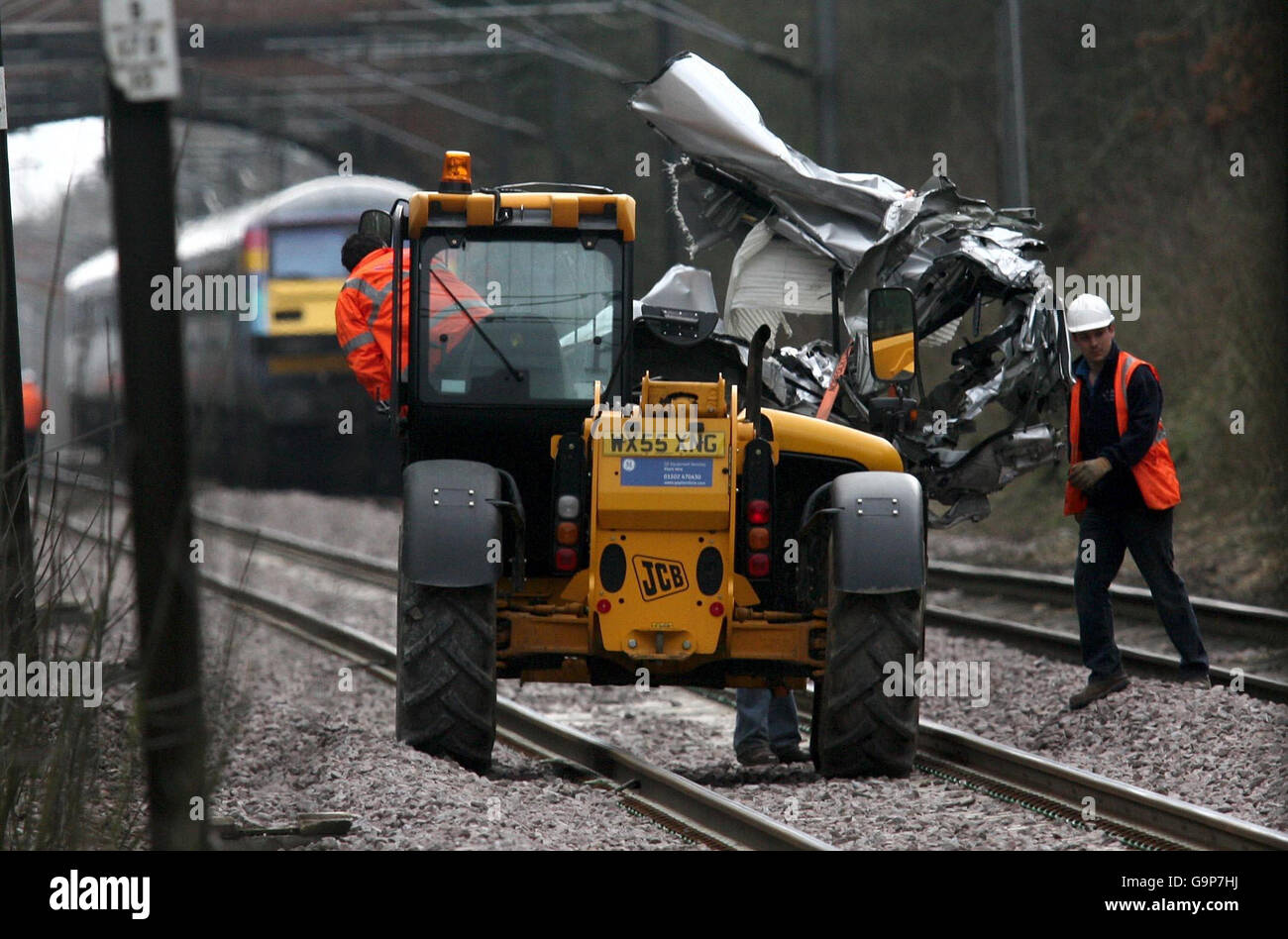 One dead as train hits car. Wreckage of a car is removed following a ...