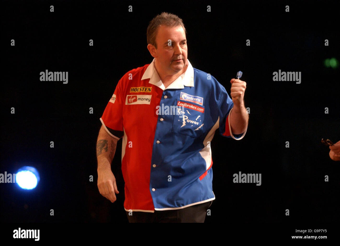 Phil Taylor celebrates winning a set against Raymond van Barneveld ...