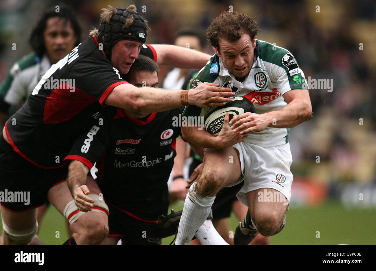 London Irish's Paul Hodgson (right) tries to escape a challenge from ...