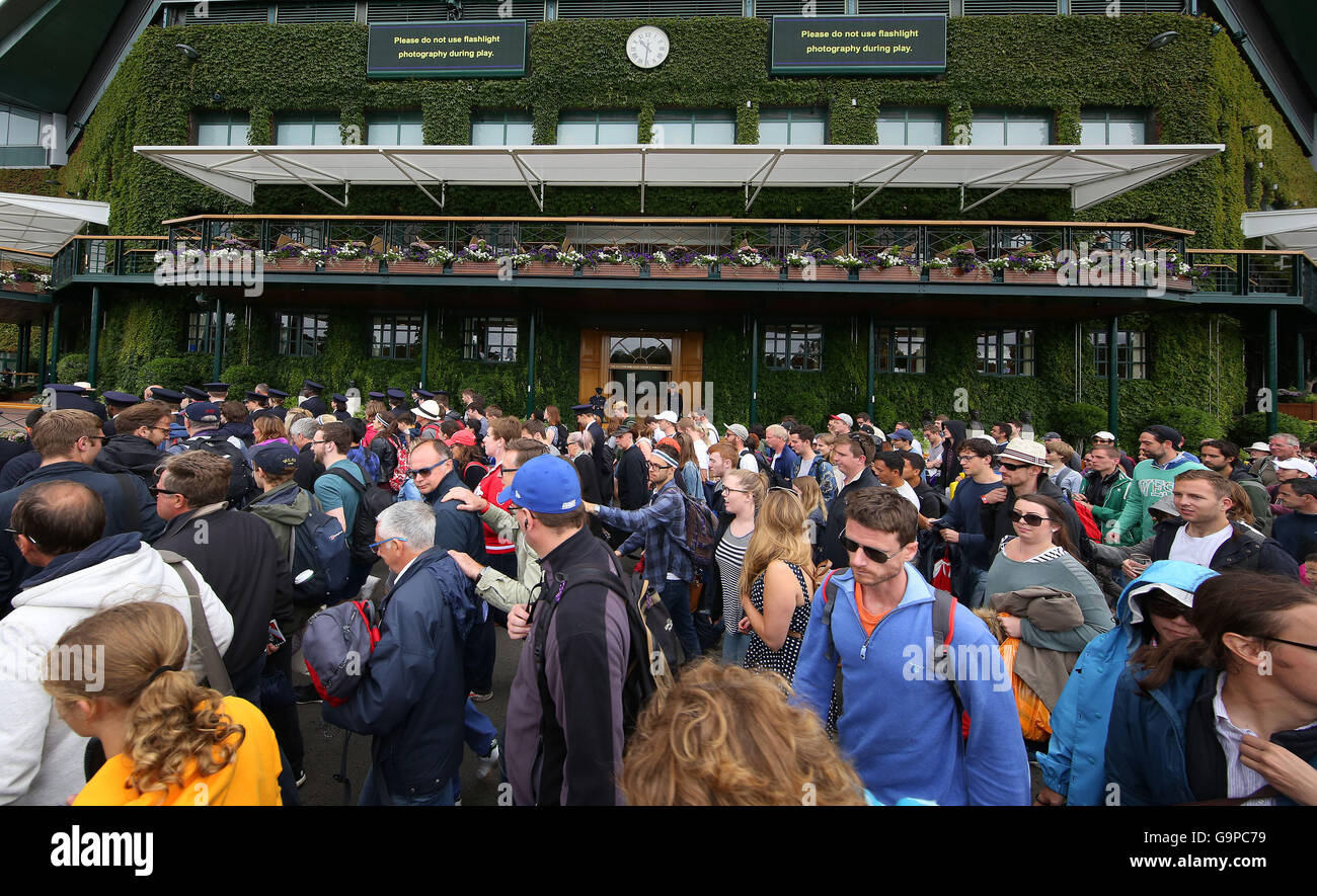 Spectators are led in on day five of the Wimbledon Championships at the ...