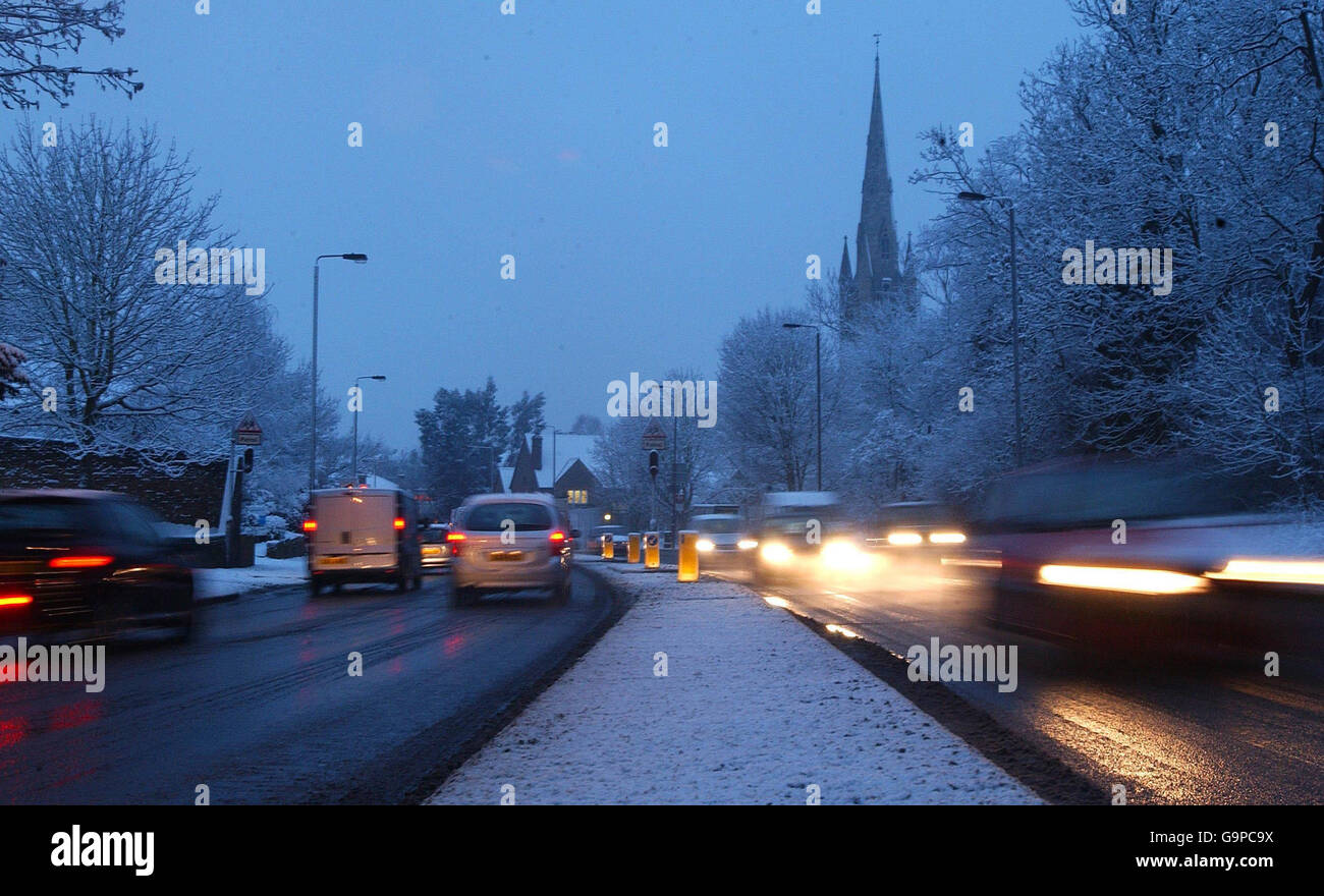 Vehicles travel through snow-covered Roehampton Lane in south west ...