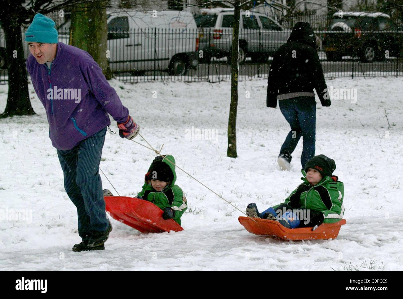 Two children pulling sledges hi-res stock photography and images - Alamy