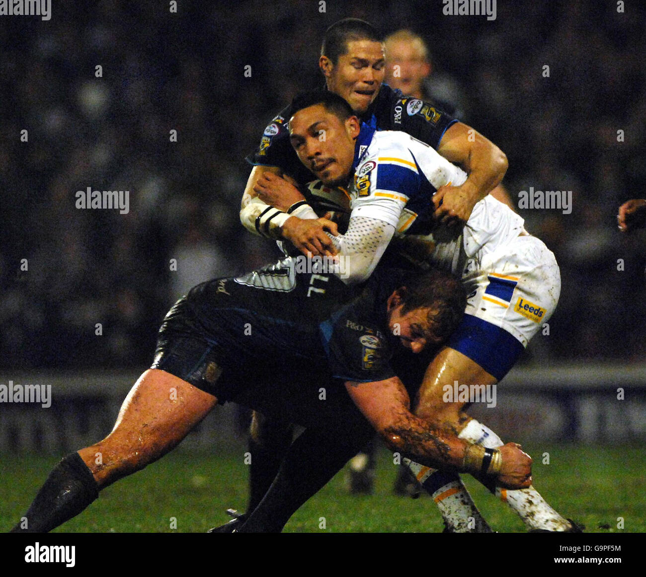 Leeds Rhinos' Clinton Toopi (centre) is tackled by Hull FC's Richard ...