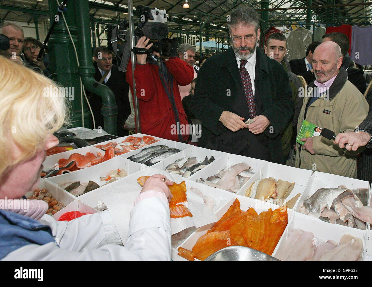 Sinn Fein Leader Gerry Adams (centre) buys fish in St Georges Market in ...