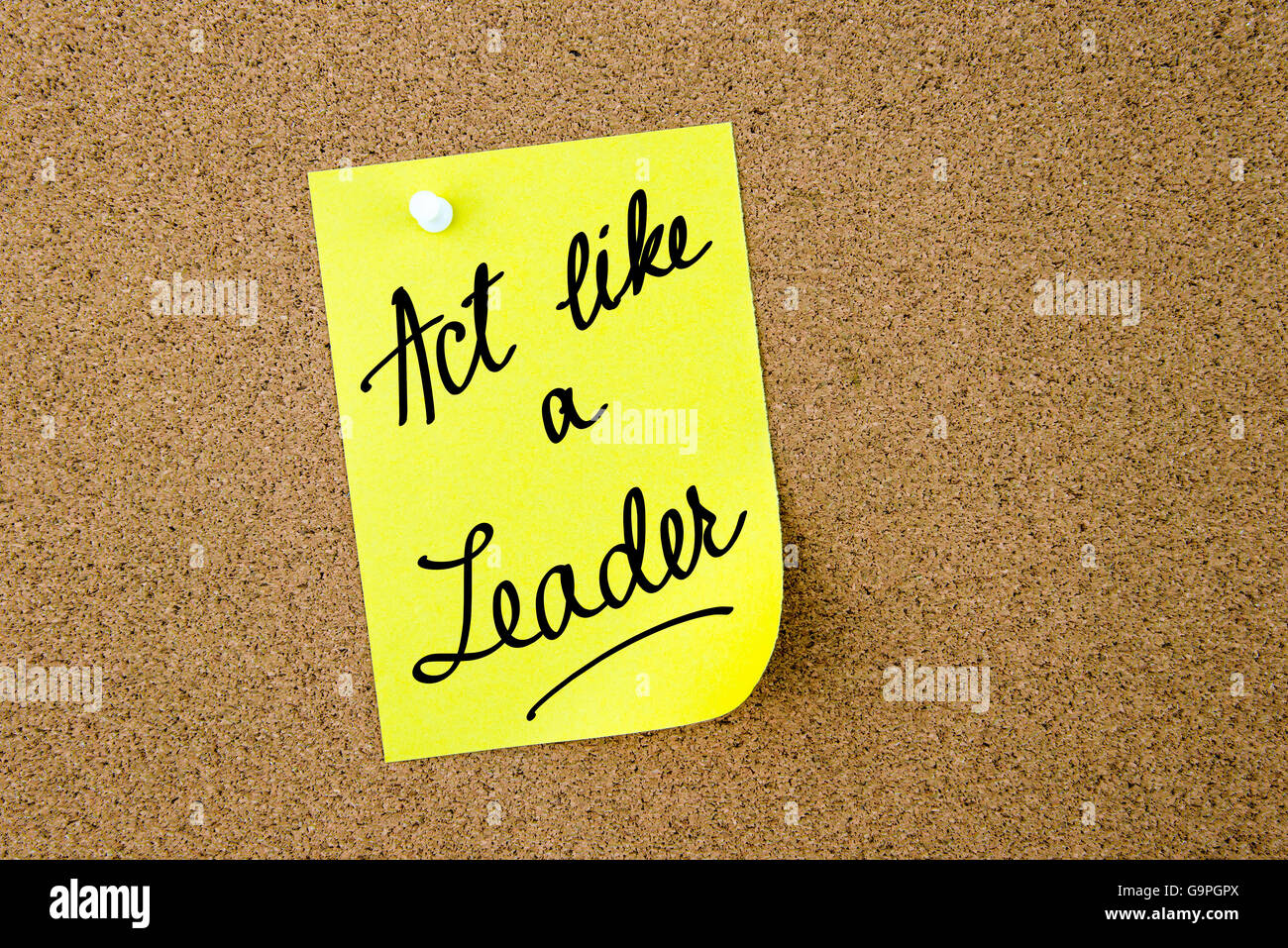 Act Like A Leader written on yellow paper note pinned on cork board ...