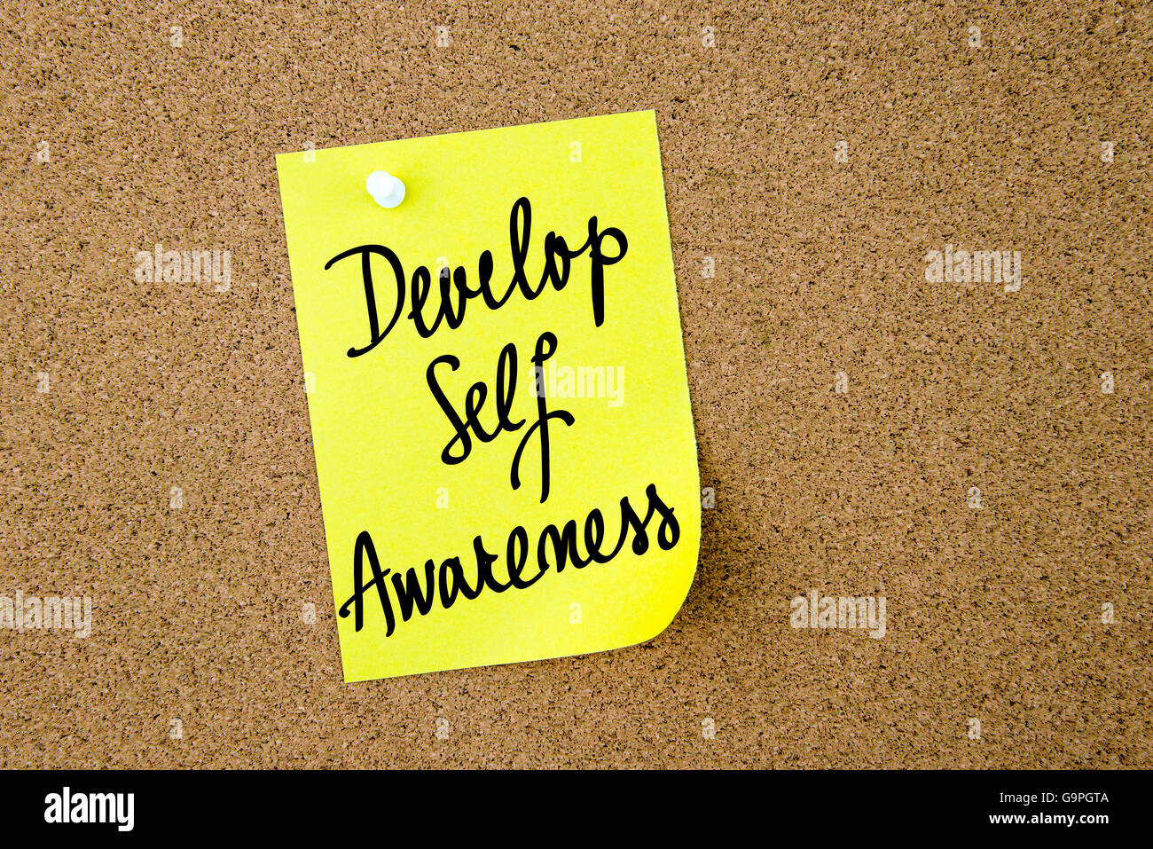Develop Self Awareness written on yellow paper note pinned on cork ...