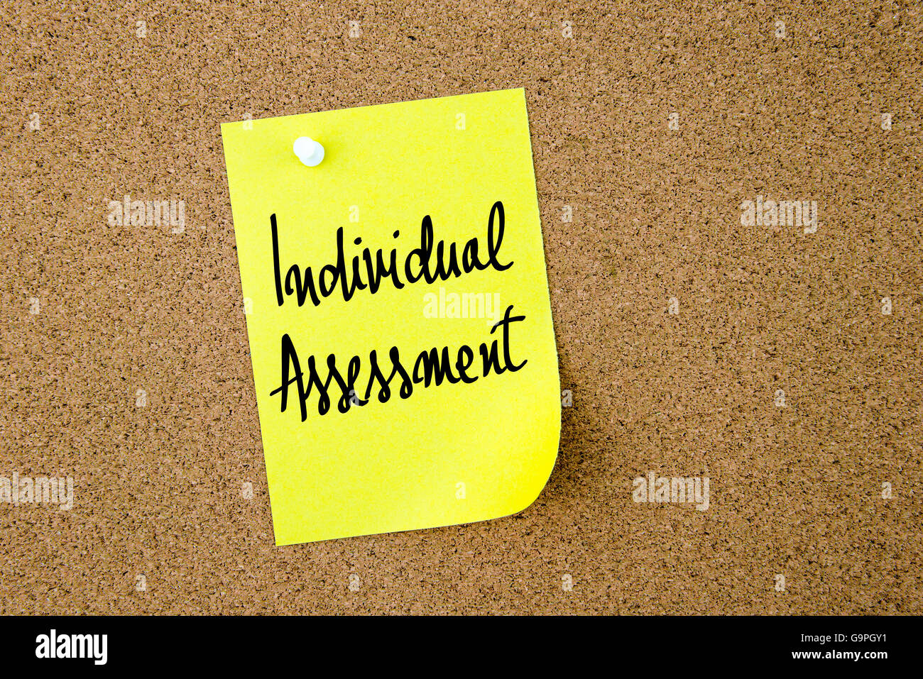 Individual Assessment written on yellow paper note pinned on cork board ...