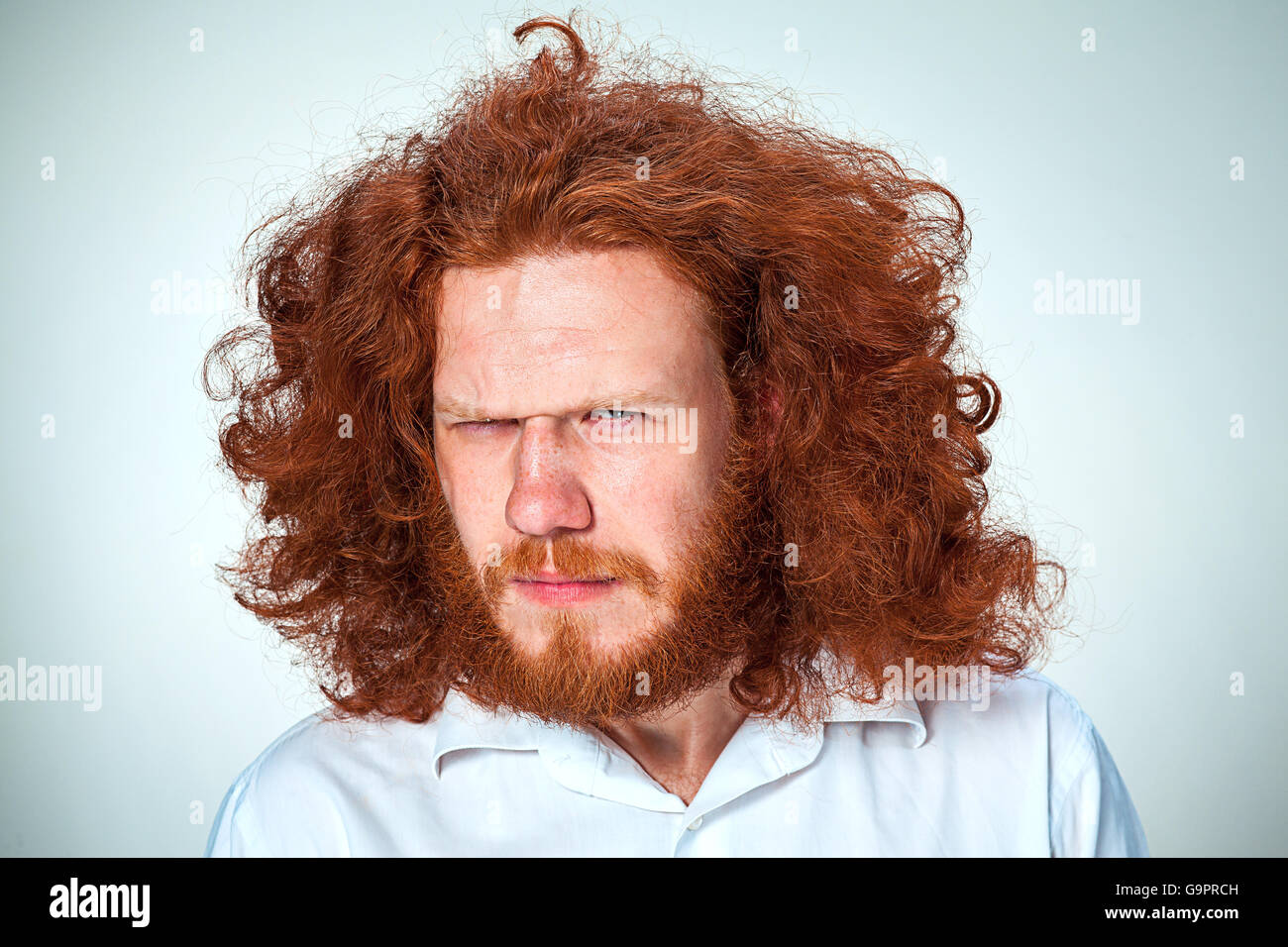 The young angry man with long red hair Stock Photo - Alamy