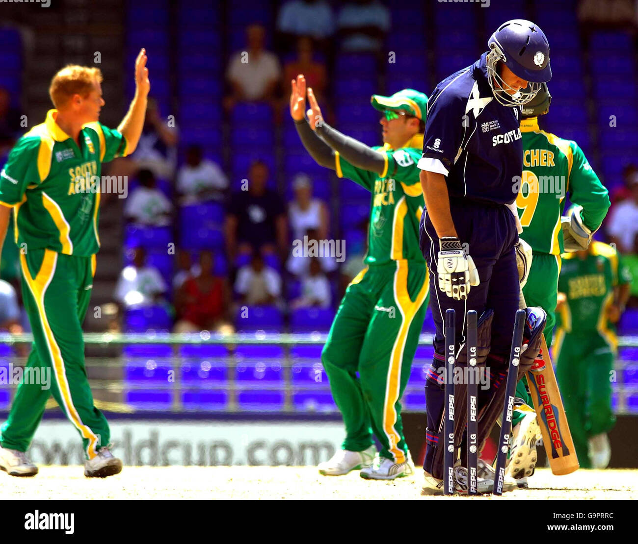 Scotland's Colin Smith (right) bowled by South Africa's Shaun Pollock ...