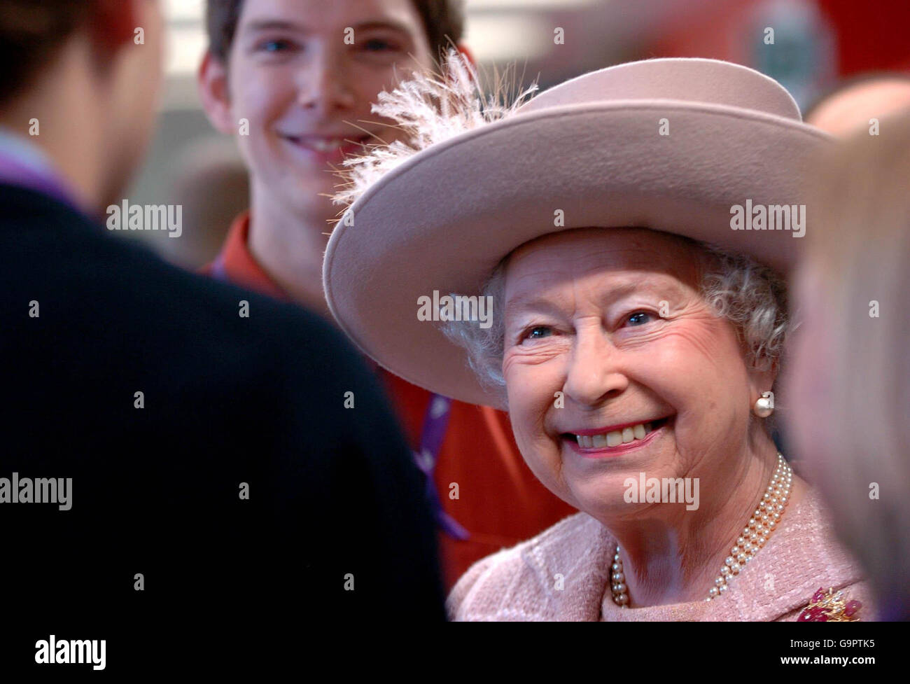 Britain's Queen Elizabeth II talks to students during a tour of the ...