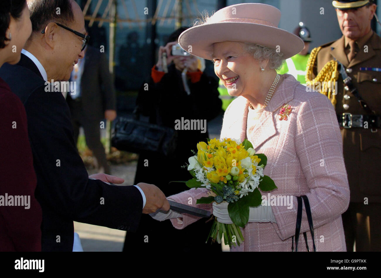 Britain's Queen Elizabeth II receives a gift from Li Ka Shing during a ...