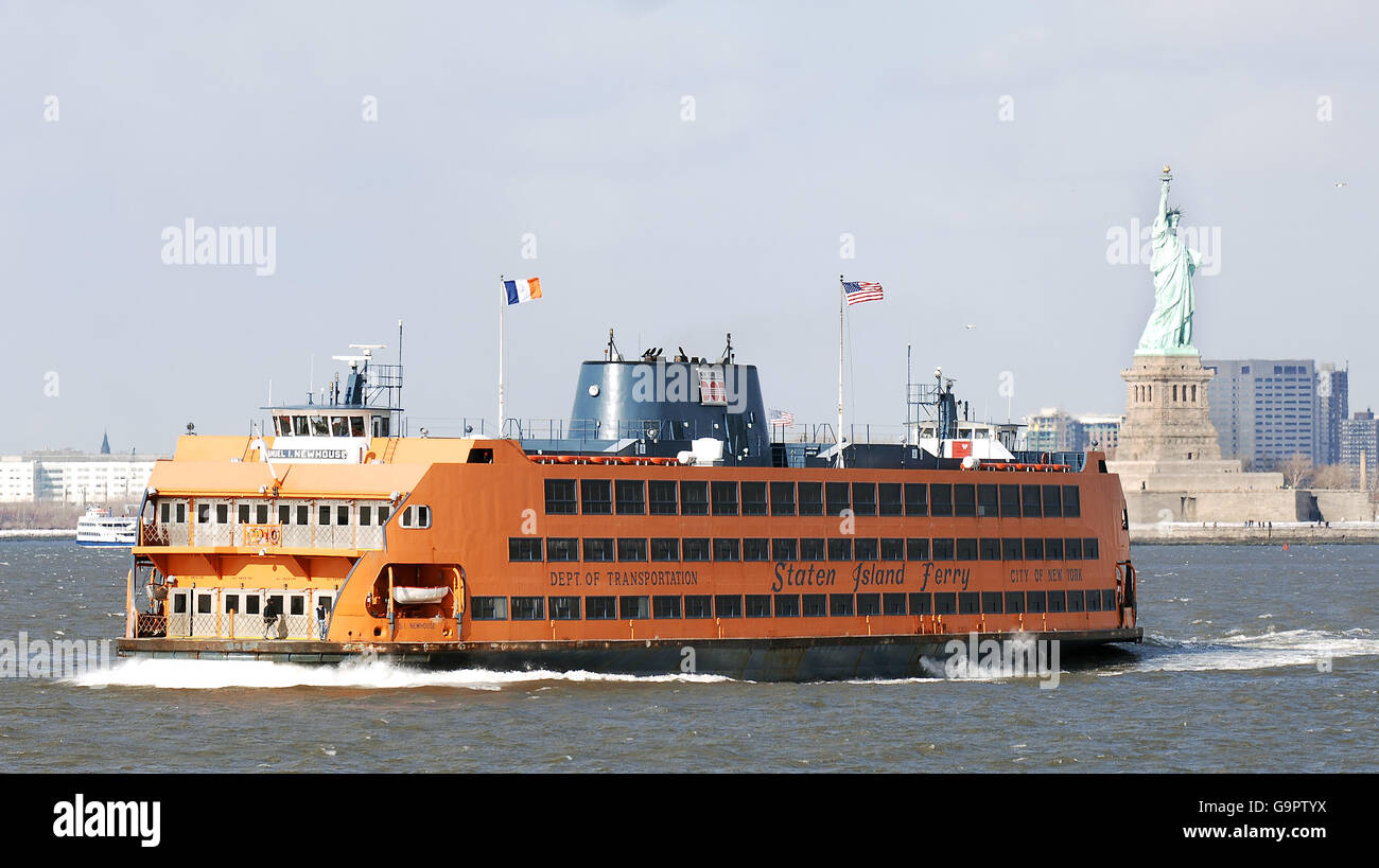 A Staten Island Ferry passes the Statue of Liberty, on its journey from ...