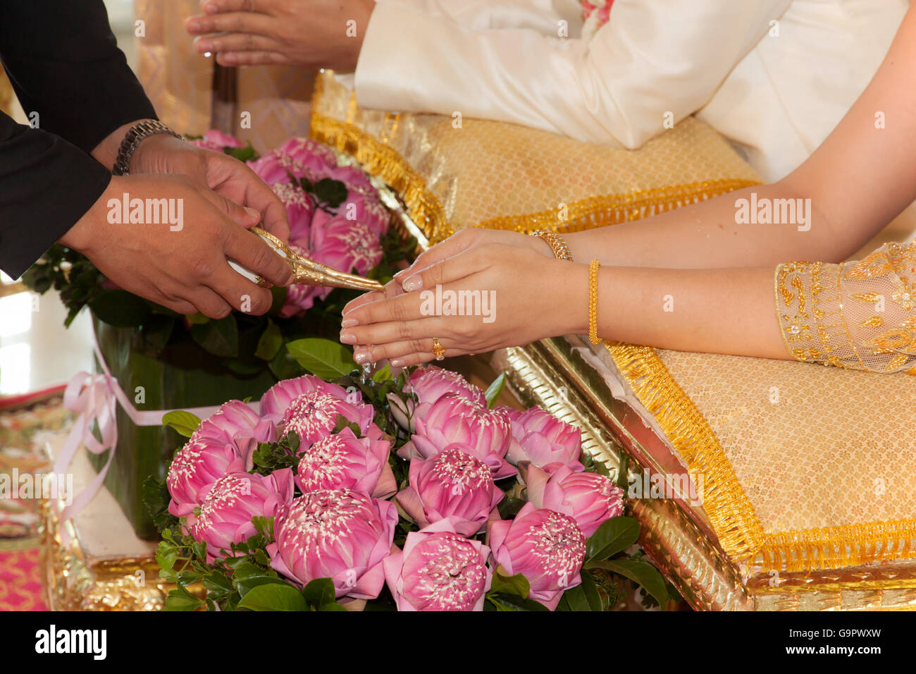 Close-up of a bride during a traditional Buddhist wedding in Thailand ...