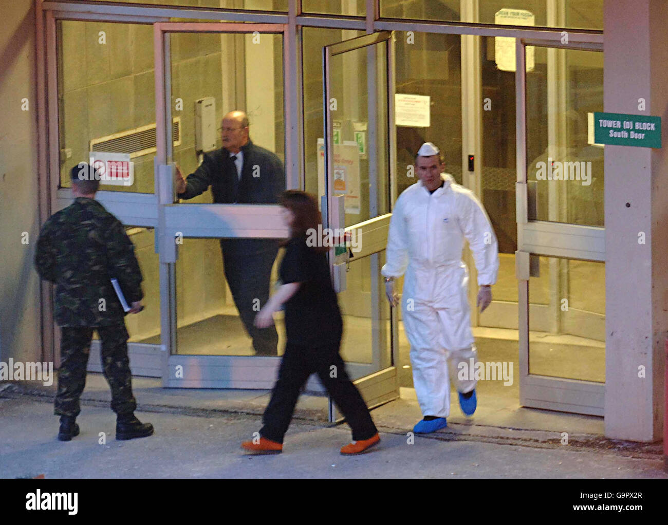 Bomb disposal (left) and forensic officers (right) amongst workers at ...