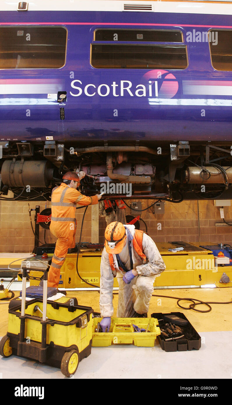 Engineers underneath a train at work after Tavish Scott M.S.P Transport ...