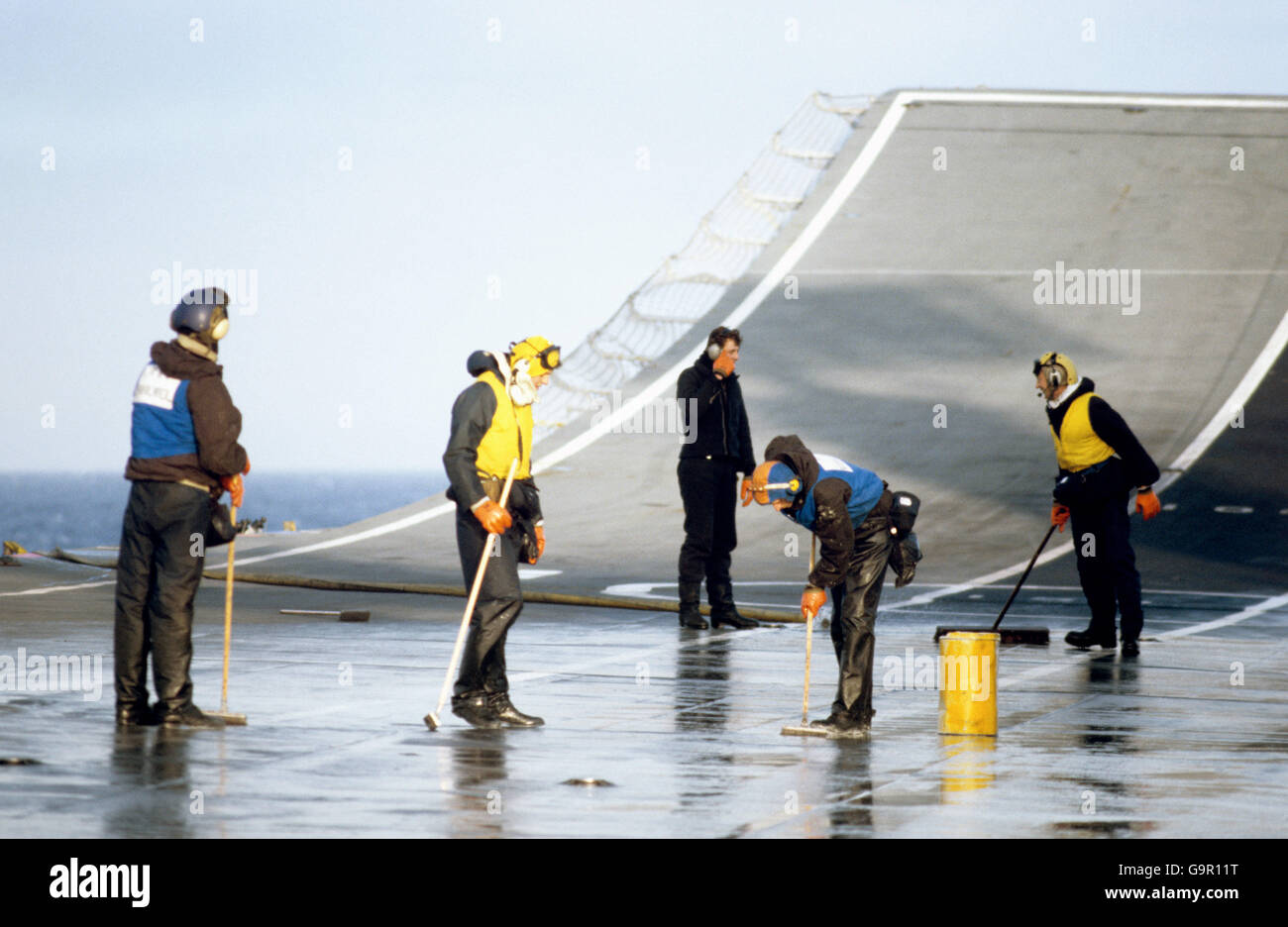 The crew of HMS Hermes scrubbing the flight deck of the carrier now on ...