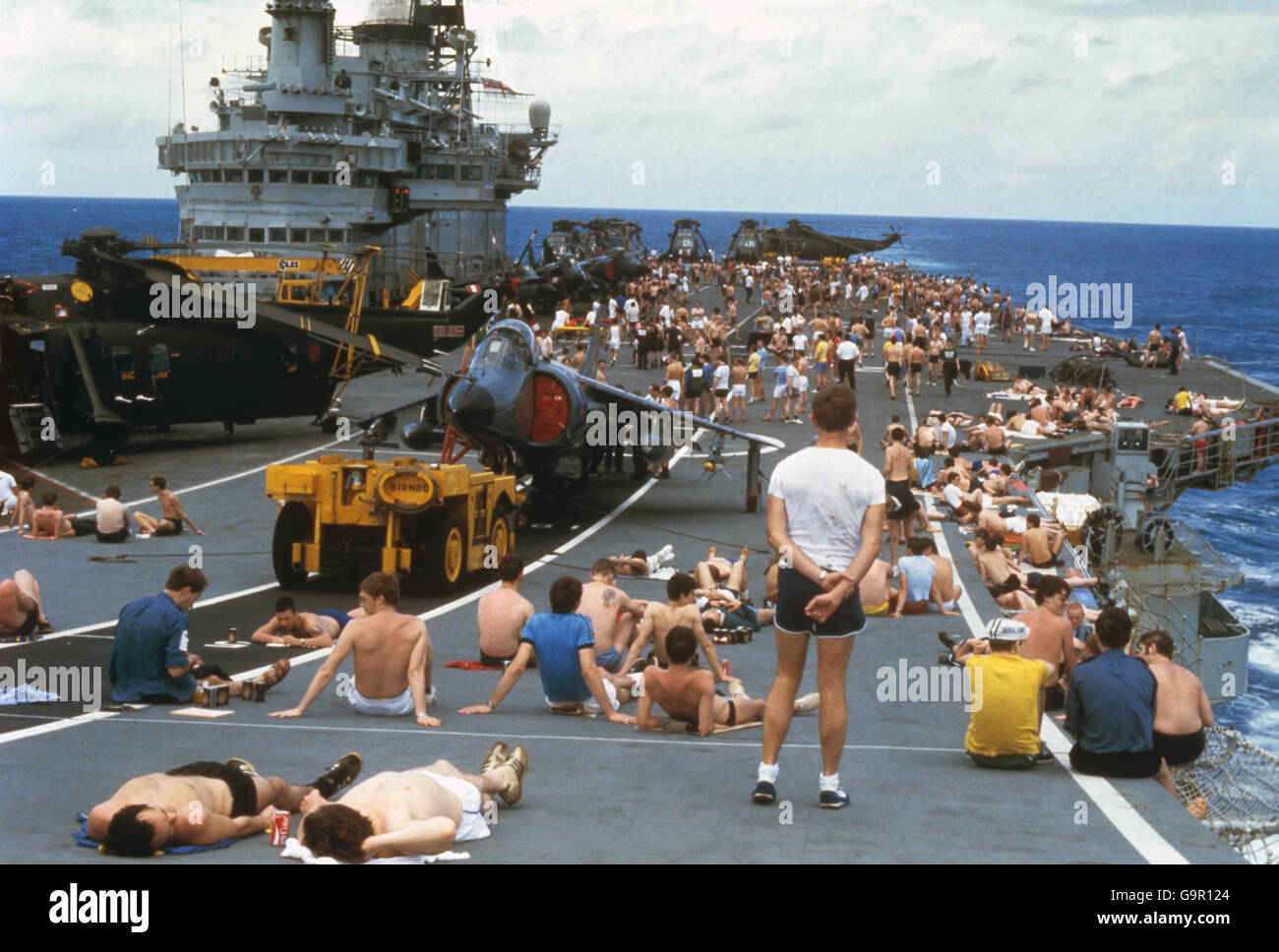Crew on board the HMS Hermes relax in the sun on route to the Falkland ...