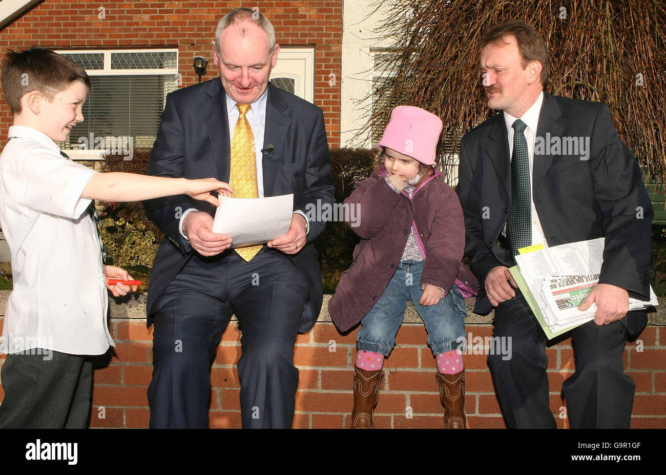 Nationalist SDLP leader Mark Durkan (second left) signs an autograph ...