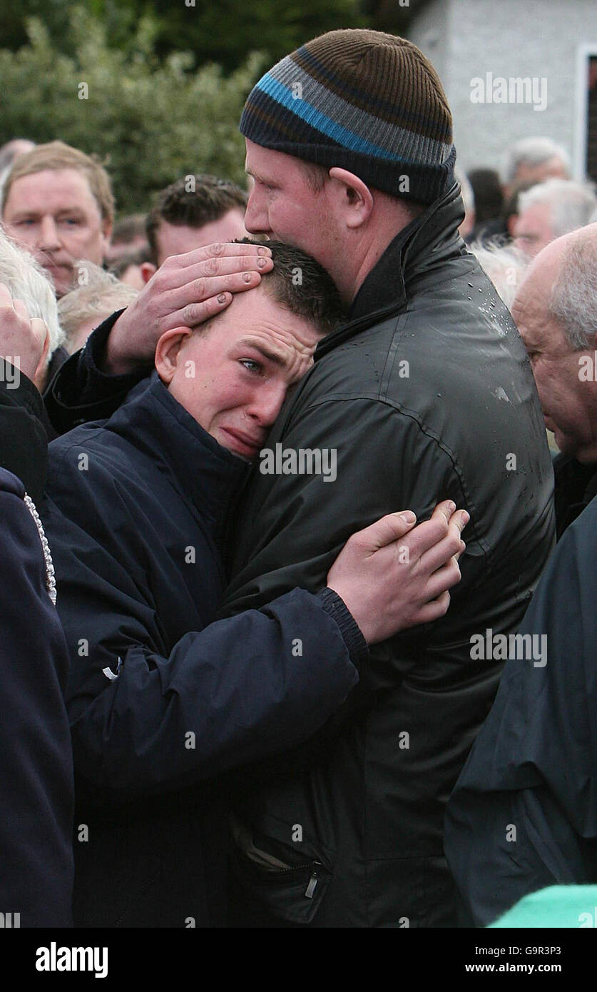 Niall Liston, the son of volunteer firefighter Mike Liston is comforted ...