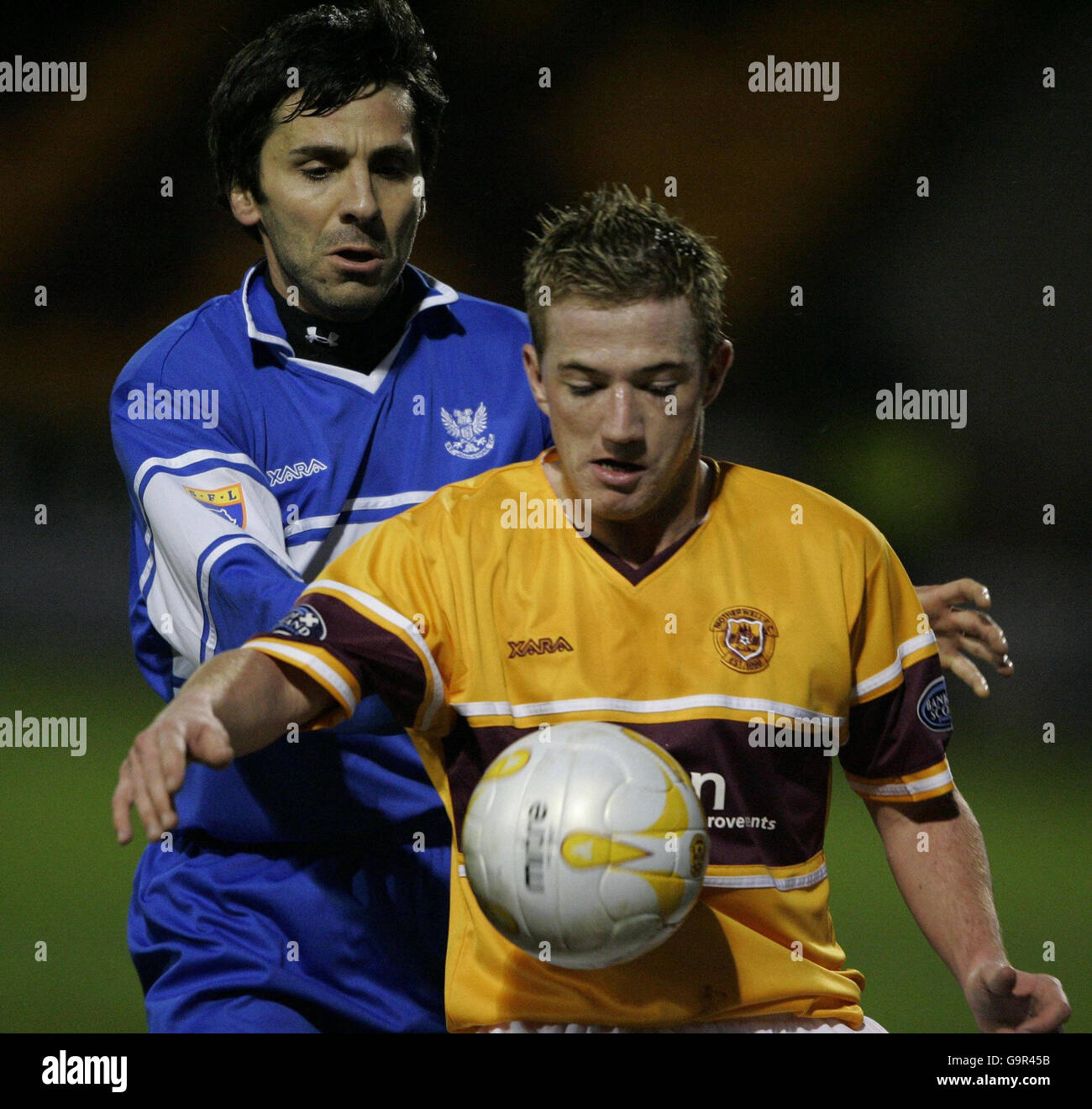 Motherwell's Ross McCormack challenges St Johnstone's Goran Stanic ...