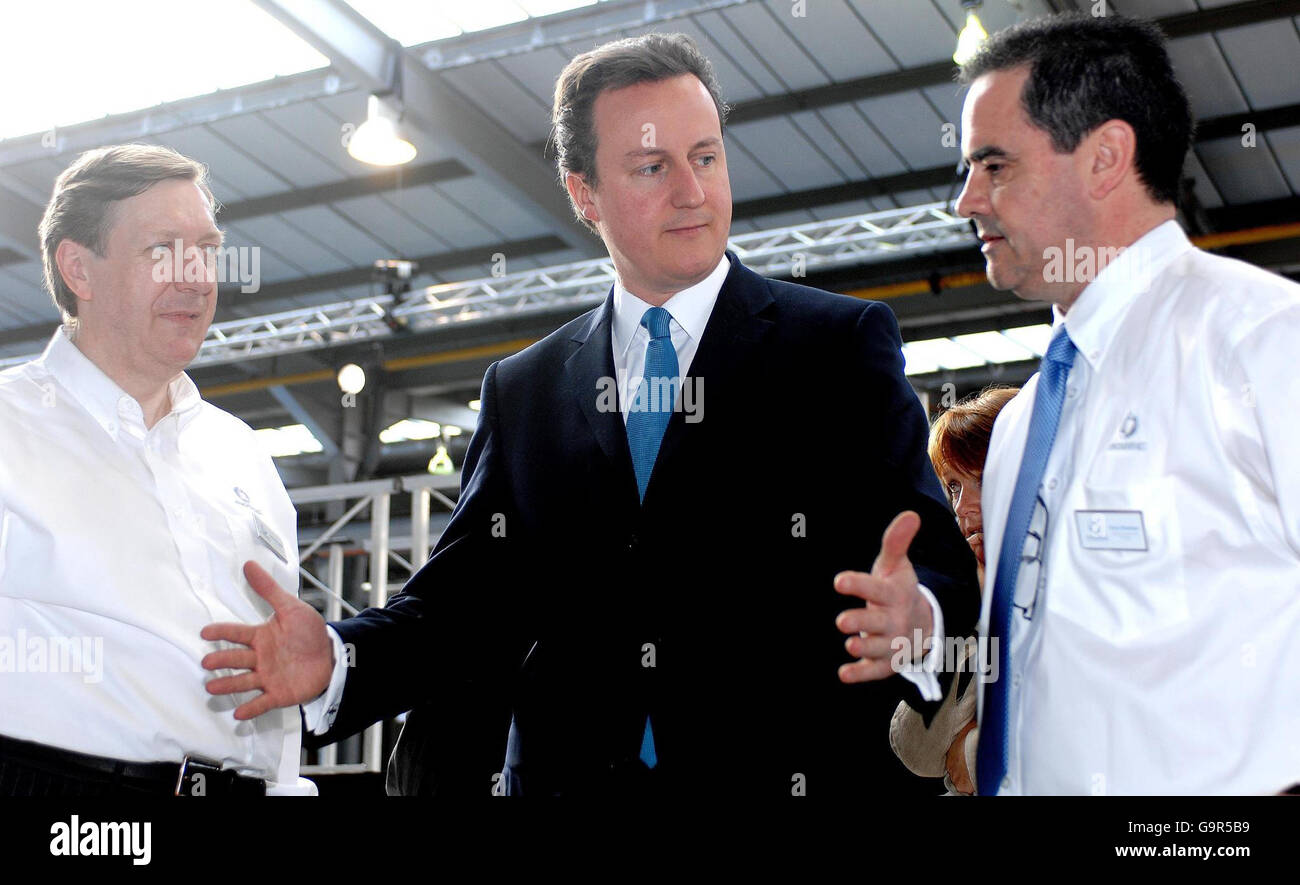 Conservative leader David Cameron talks to employees at the opening of ...