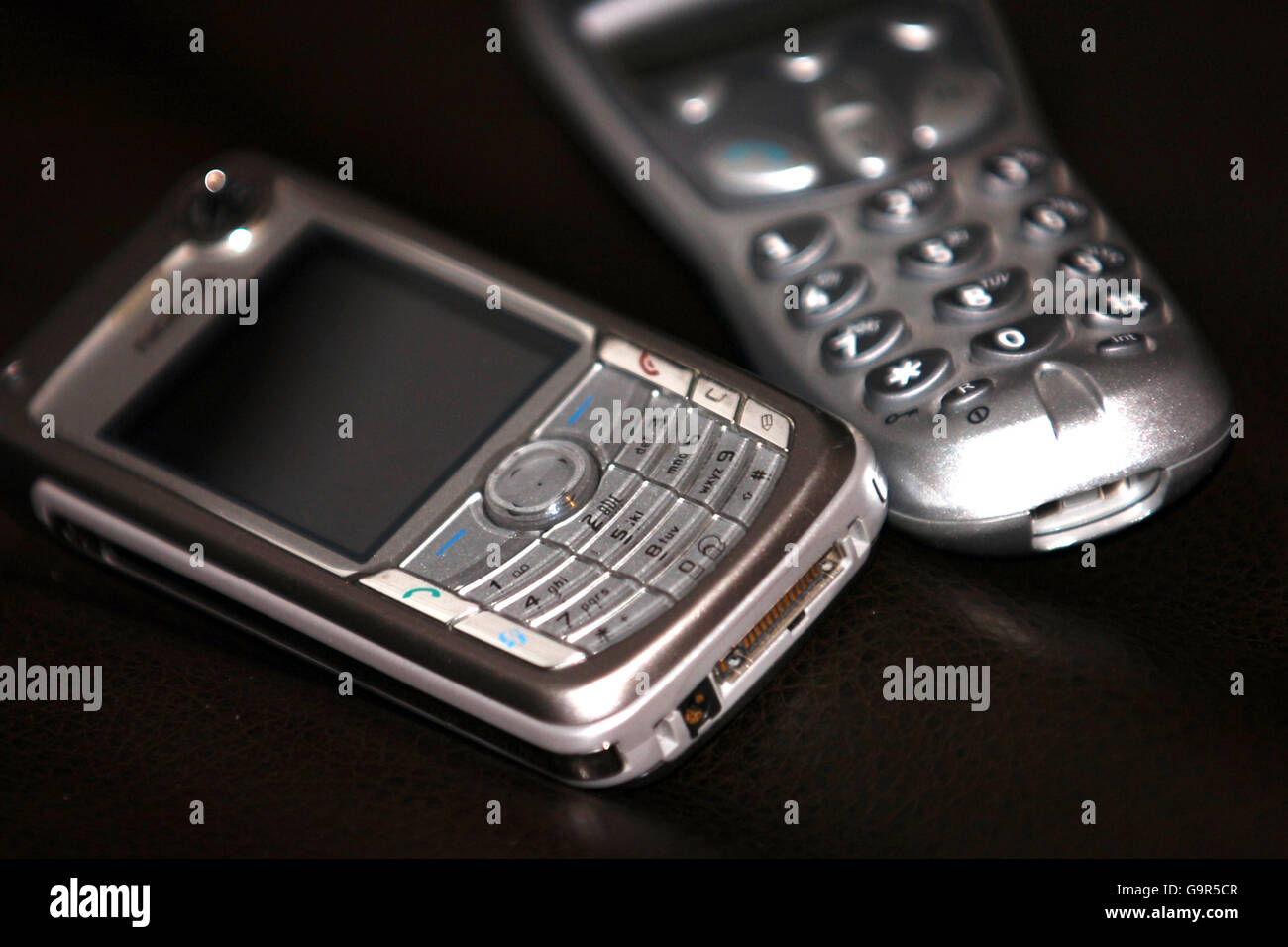A mobile phone along side a normal land line phone Stock Photo - Alamy