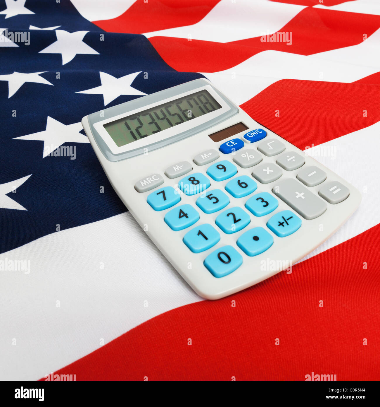 Close up studio shot as part of ruffled national flag with calculator ...