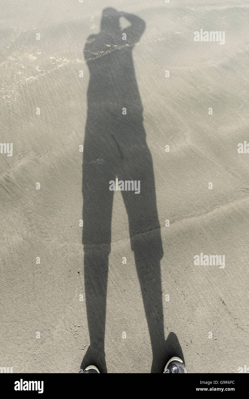 a shadow cast on the beach facing the ocean Stock Photo - Alamy