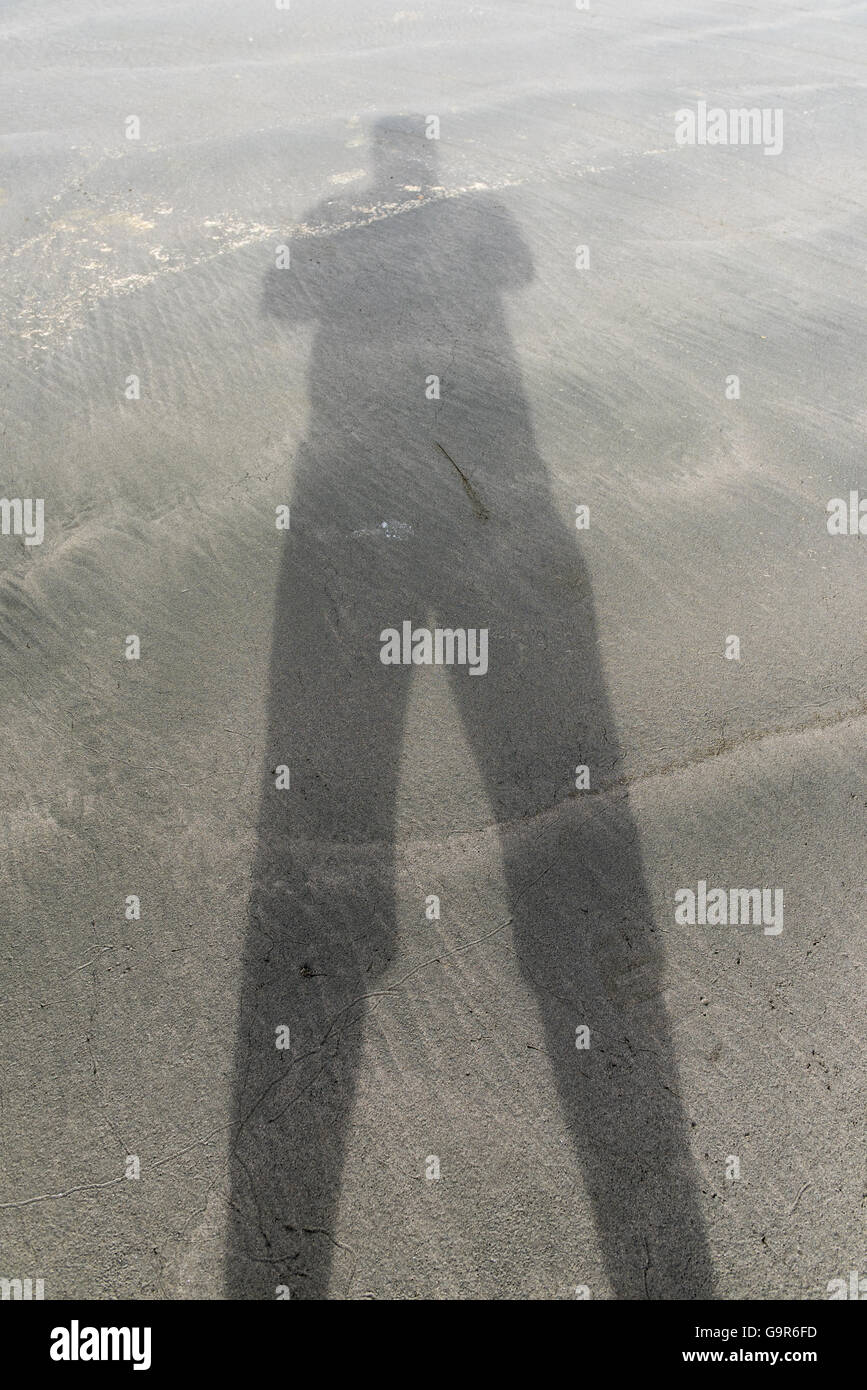 a shadow cast on the beach facing the ocean Stock Photo - Alamy
