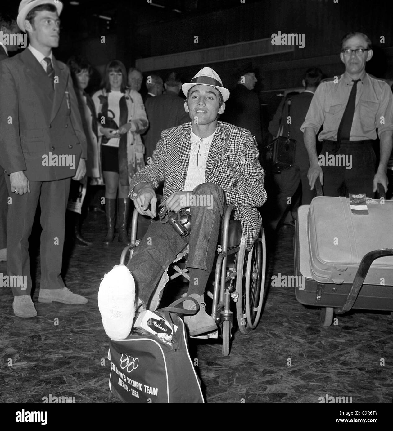 Propping up his injured limb, British Olympic boxer Terry Waller sits ...