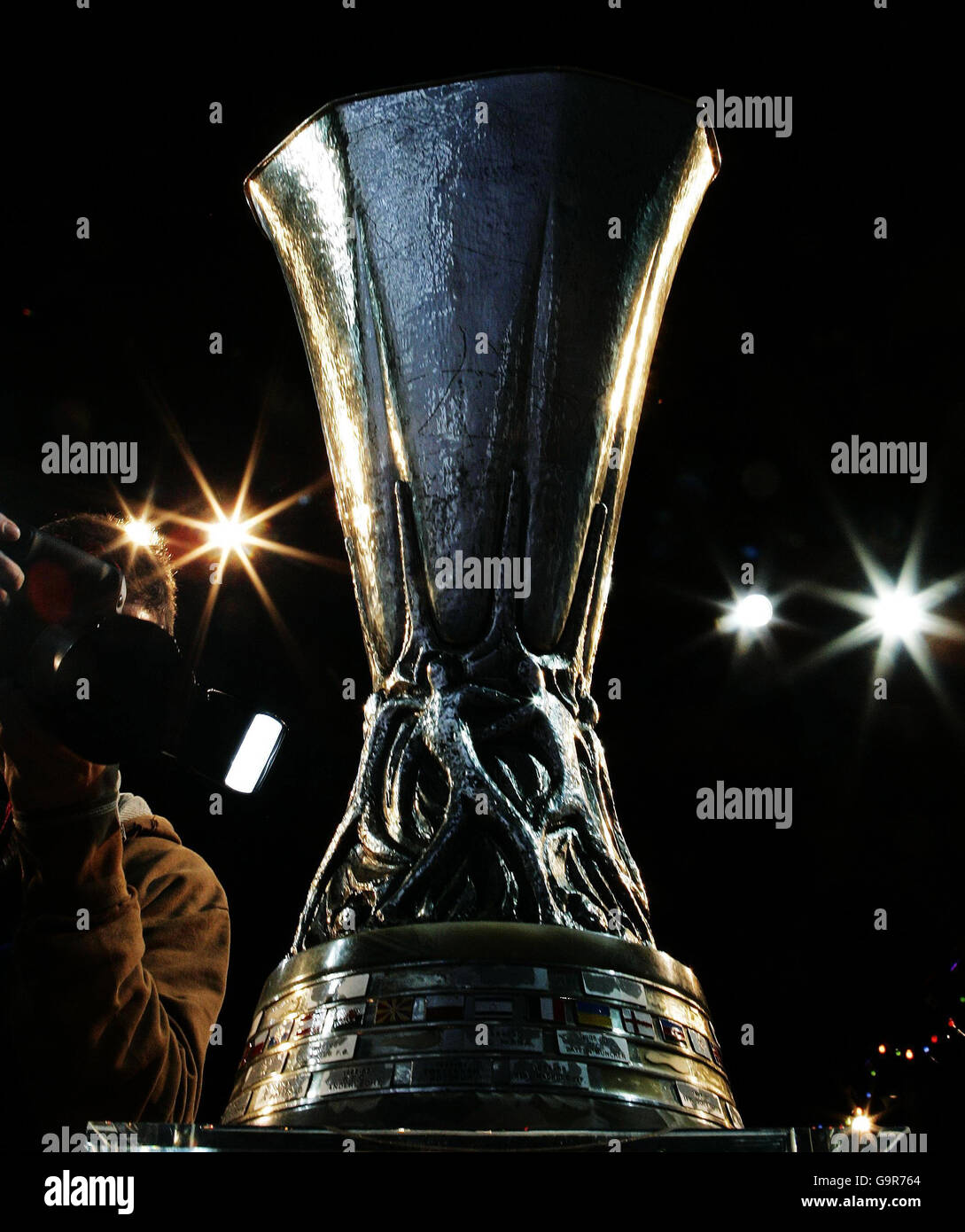A photographer takes a picture of the Uefa cup during the UEFA Cup ...